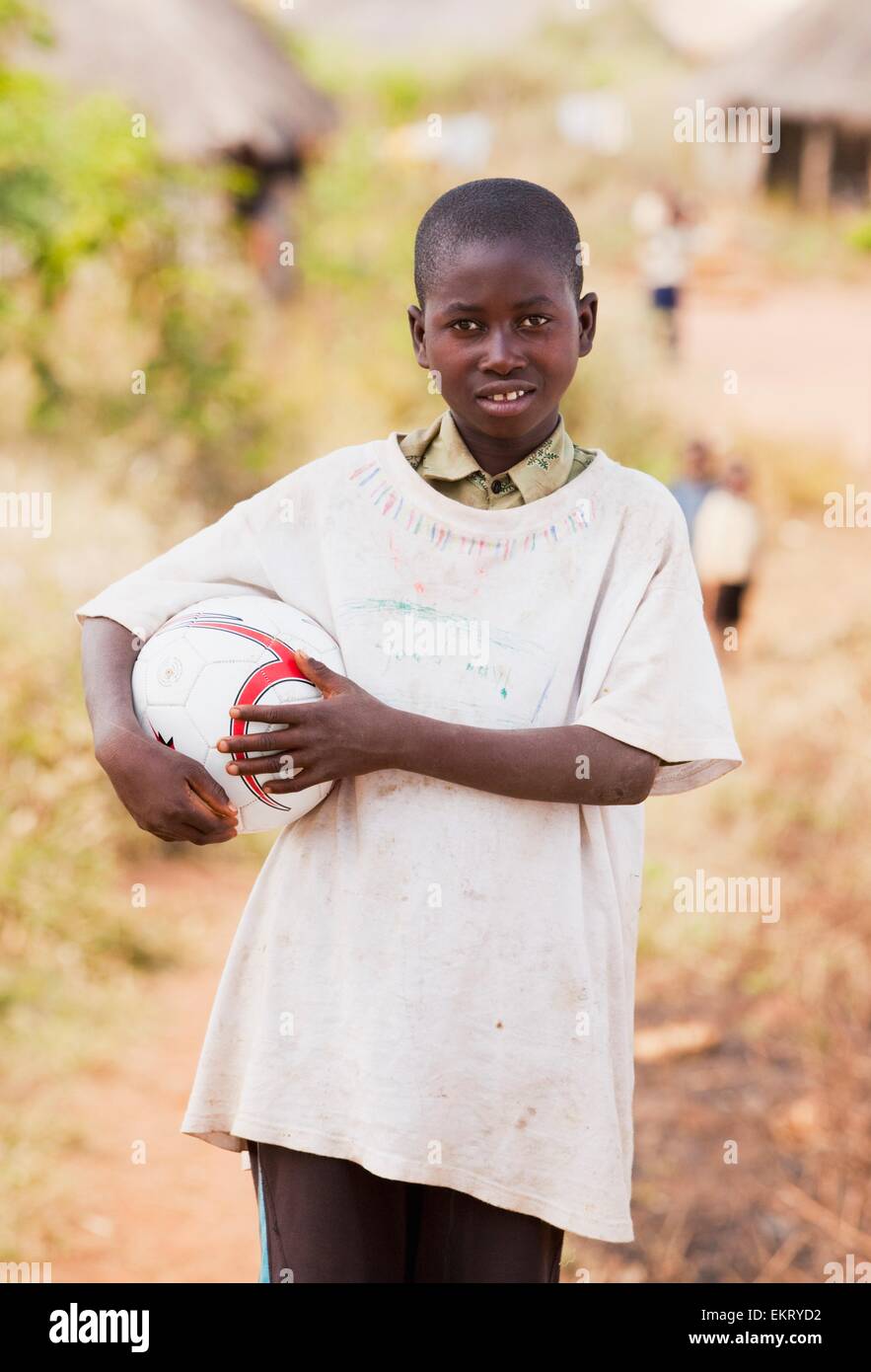 A Young Man Holding A Football; Manica, Mozambique, Africa Stock Photo ...