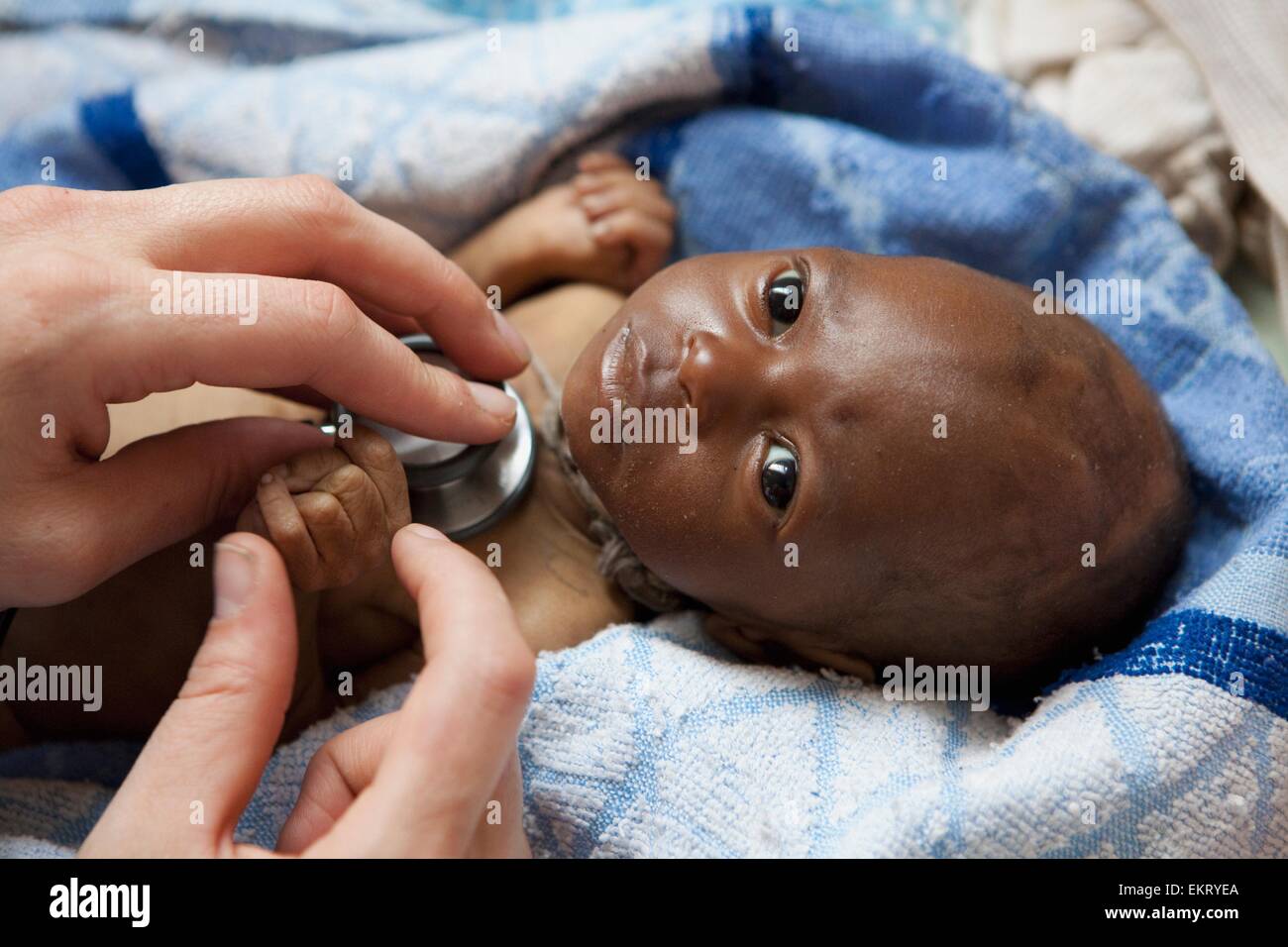 An Infant Dying Of Hiv/Aids Being Cared For By A Medical Worker; Manica ...