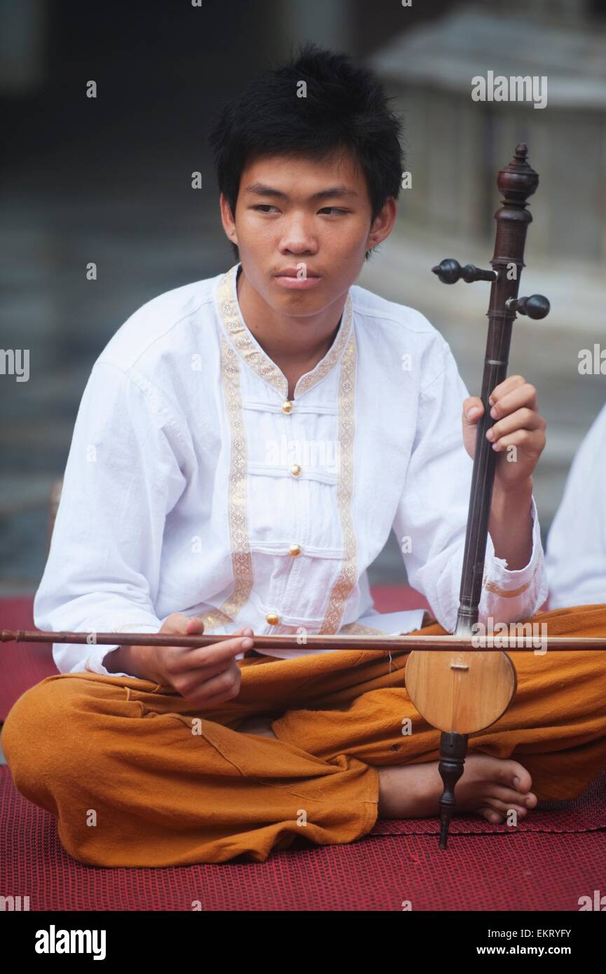 A Thai Boy Performs With A Thai Traditional Instrument; Chiang Mai ...