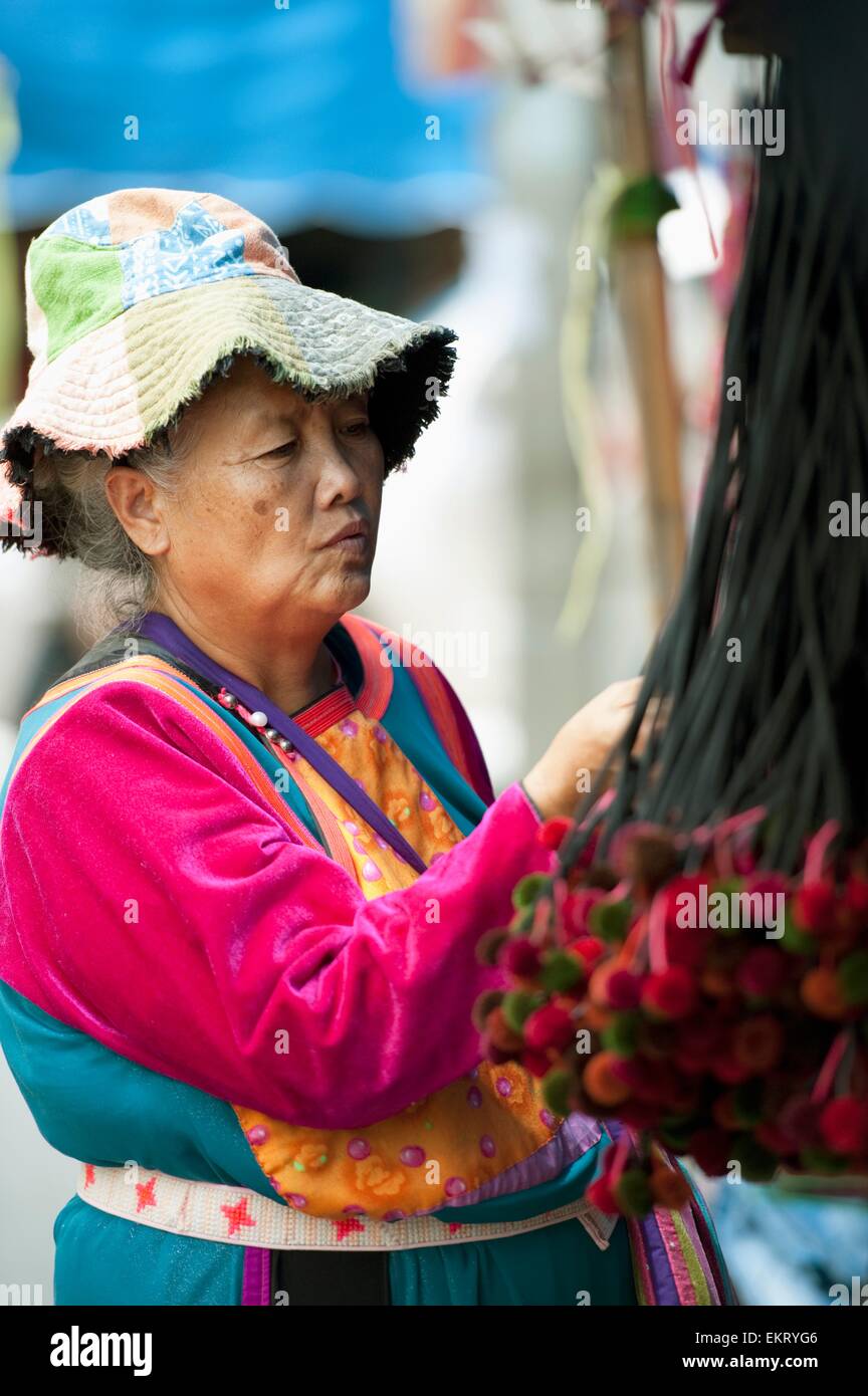 A Hill Tribe Lady In Costume (Lisu) Checks Her Goods For Sale At A ...
