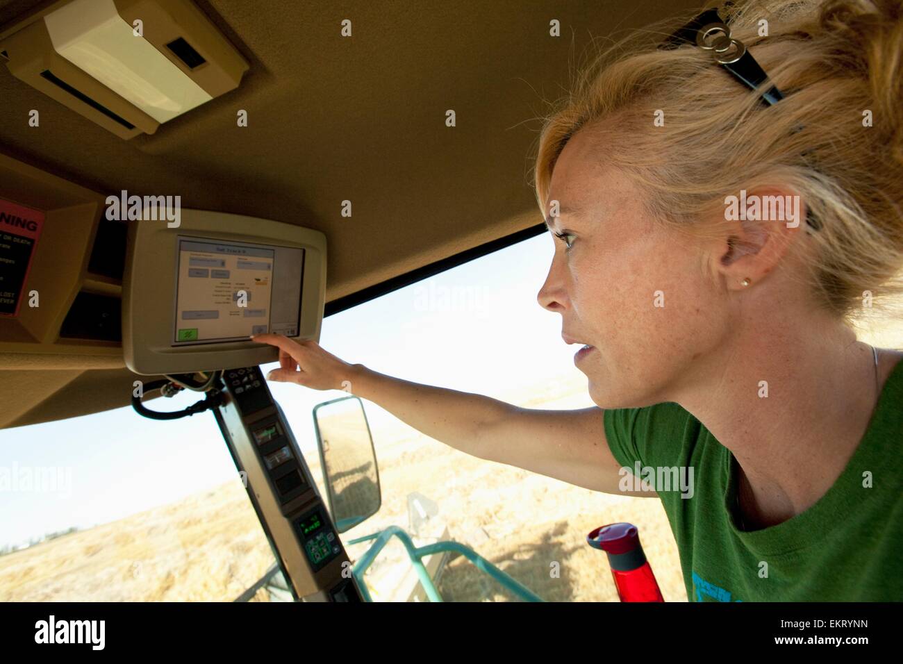 Female Farmer In Combine Using Gps; Three Hills, Alberta, Canada Stock ...
