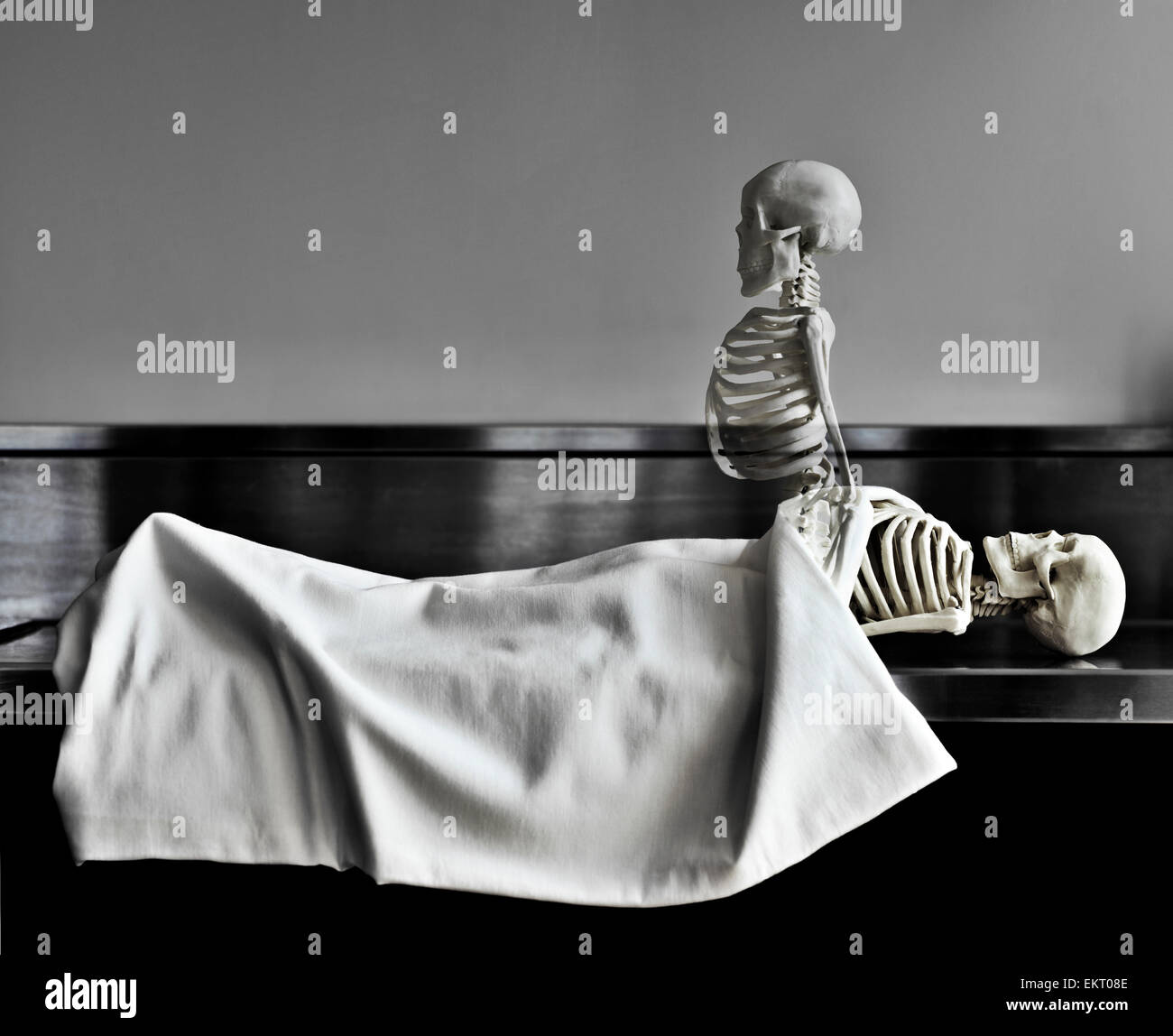 Skeleton Covered In Sheet Rising From Table Stock Photo - Alamy