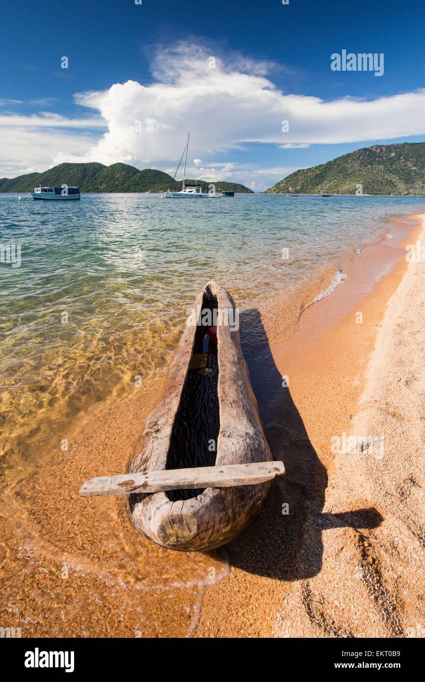 A traditional dug out canoe on a beach at Cape Maclear on the shores of ...