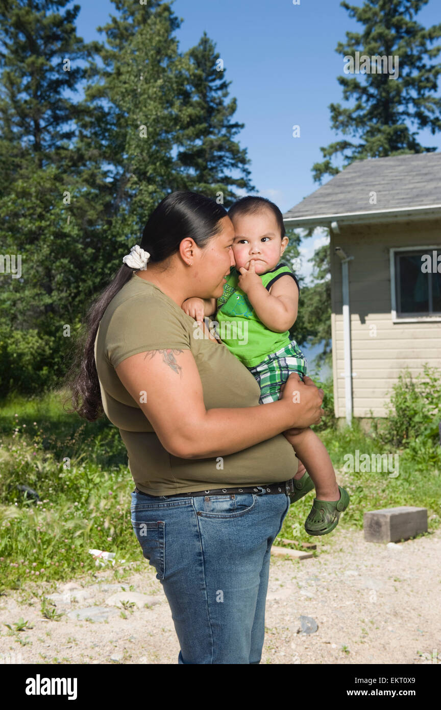 Native American Mother With Her Son Standing Outside In Front Of A Home ...