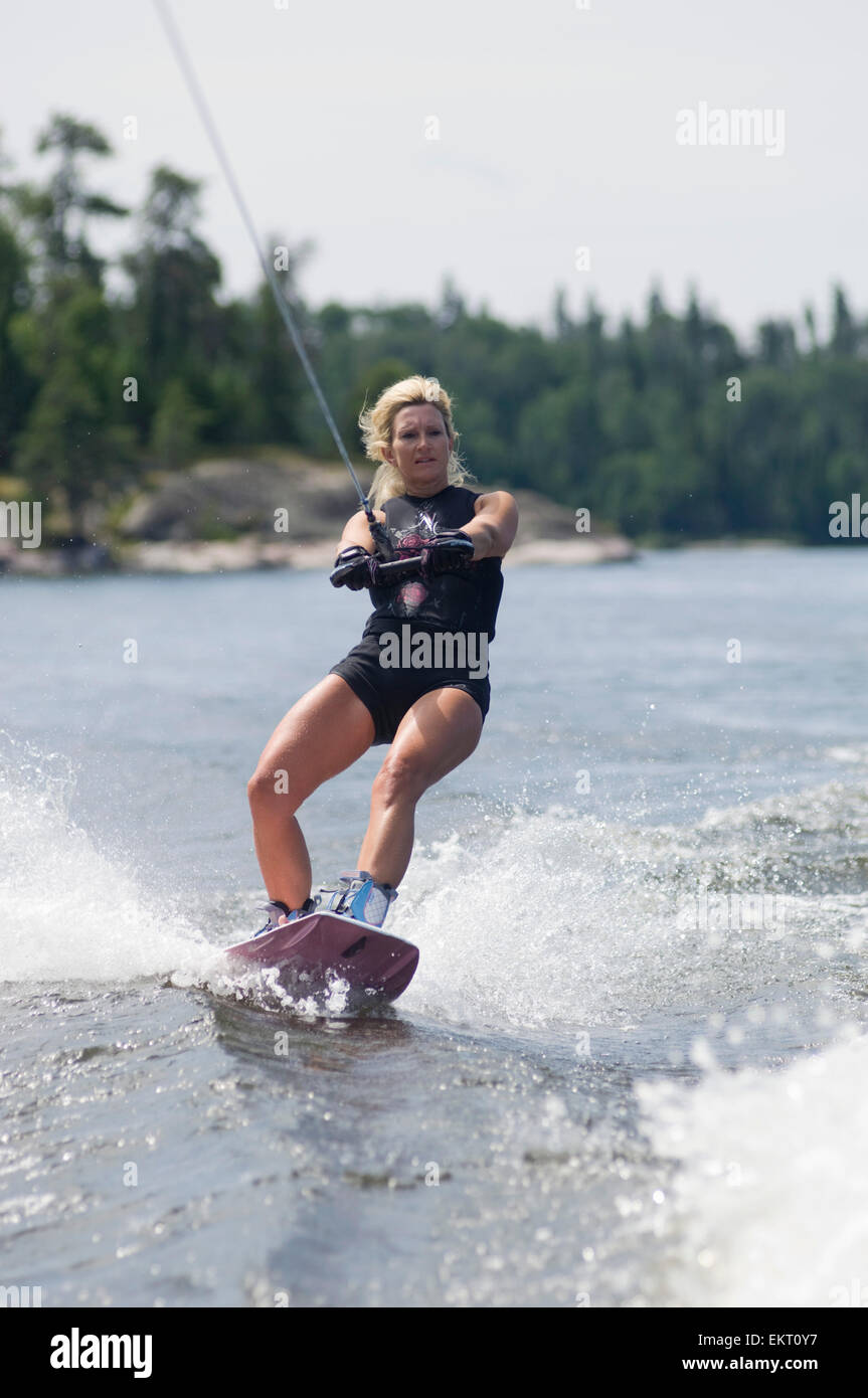 Middle Aged Woman Wakeboarding On Gunn Lake, Ontario, Canada Stock ...