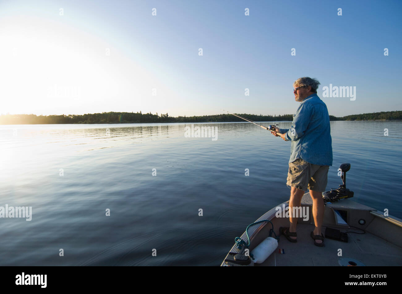 Man Fishing From His Boat On Gunn Lake, Ontario, Canada Stock Photo - Alamy