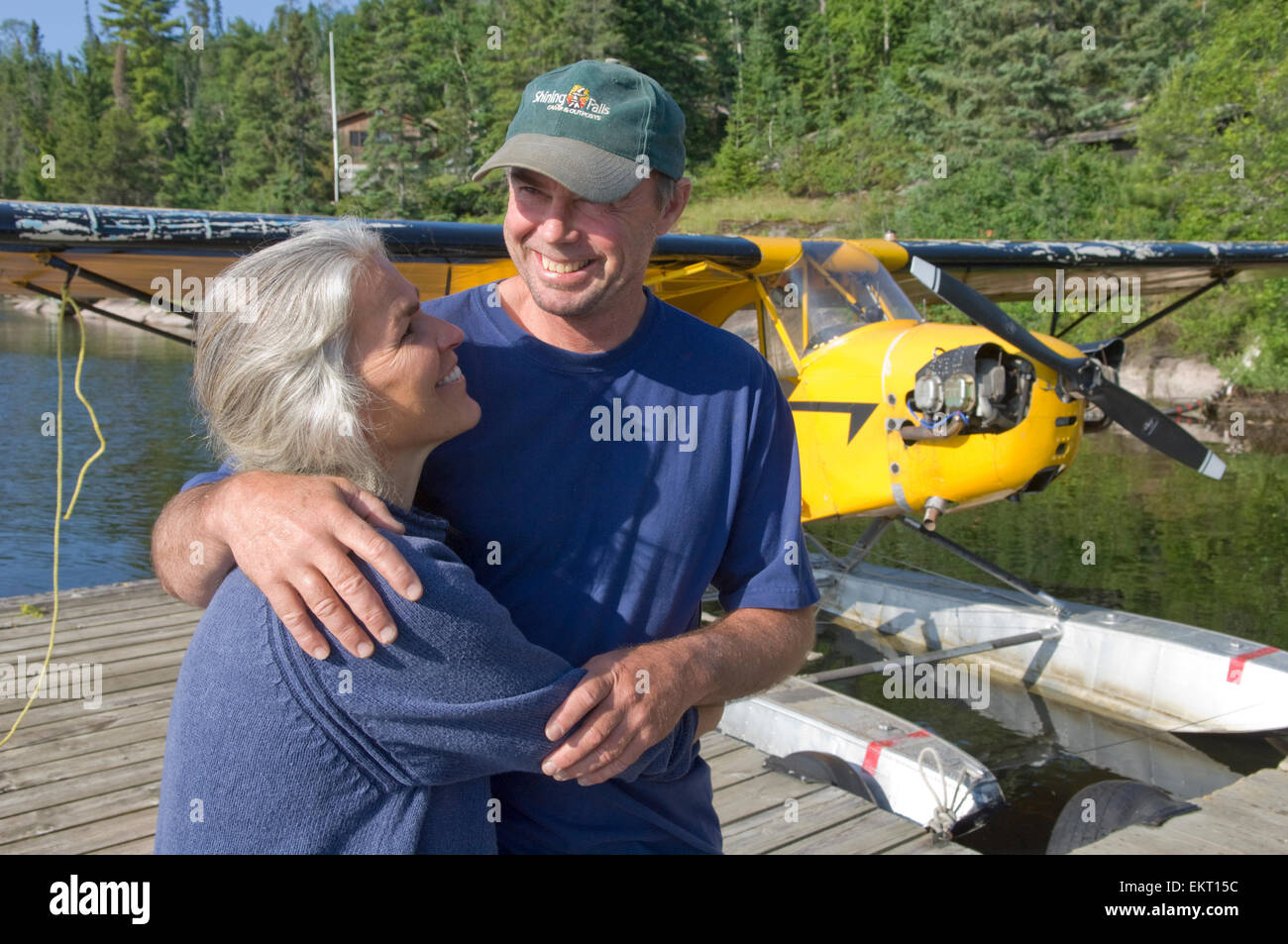 Middle Aged Couple Hugging Each Other In Front Of Their Piper Cub Float ...