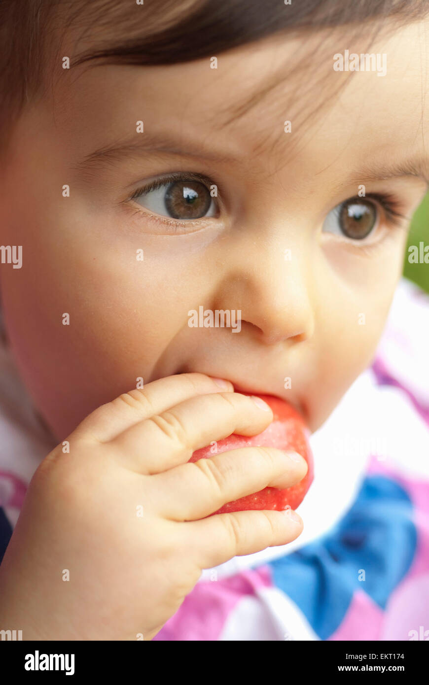 Ethnic kid eating apples hi-res stock photography and images - Alamy