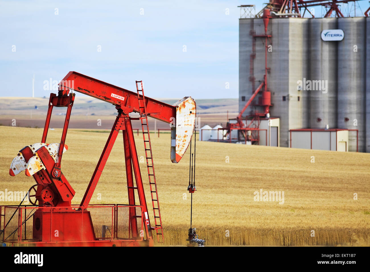 Oil Well Pump Jack, And Prairie Wheat Field. Inland Grain Terminal In ...