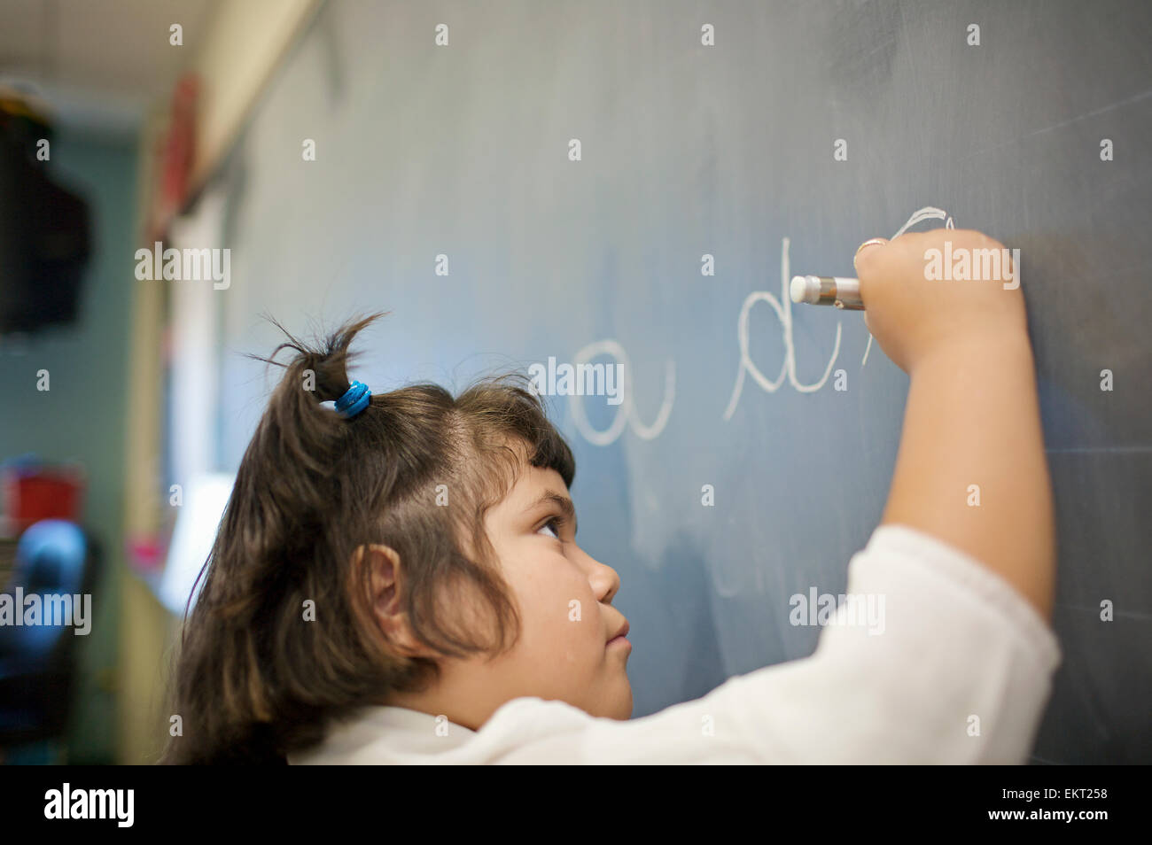 Hispanic Girl Writing On Blackboard In An Esl School; Guelph Ontario ...