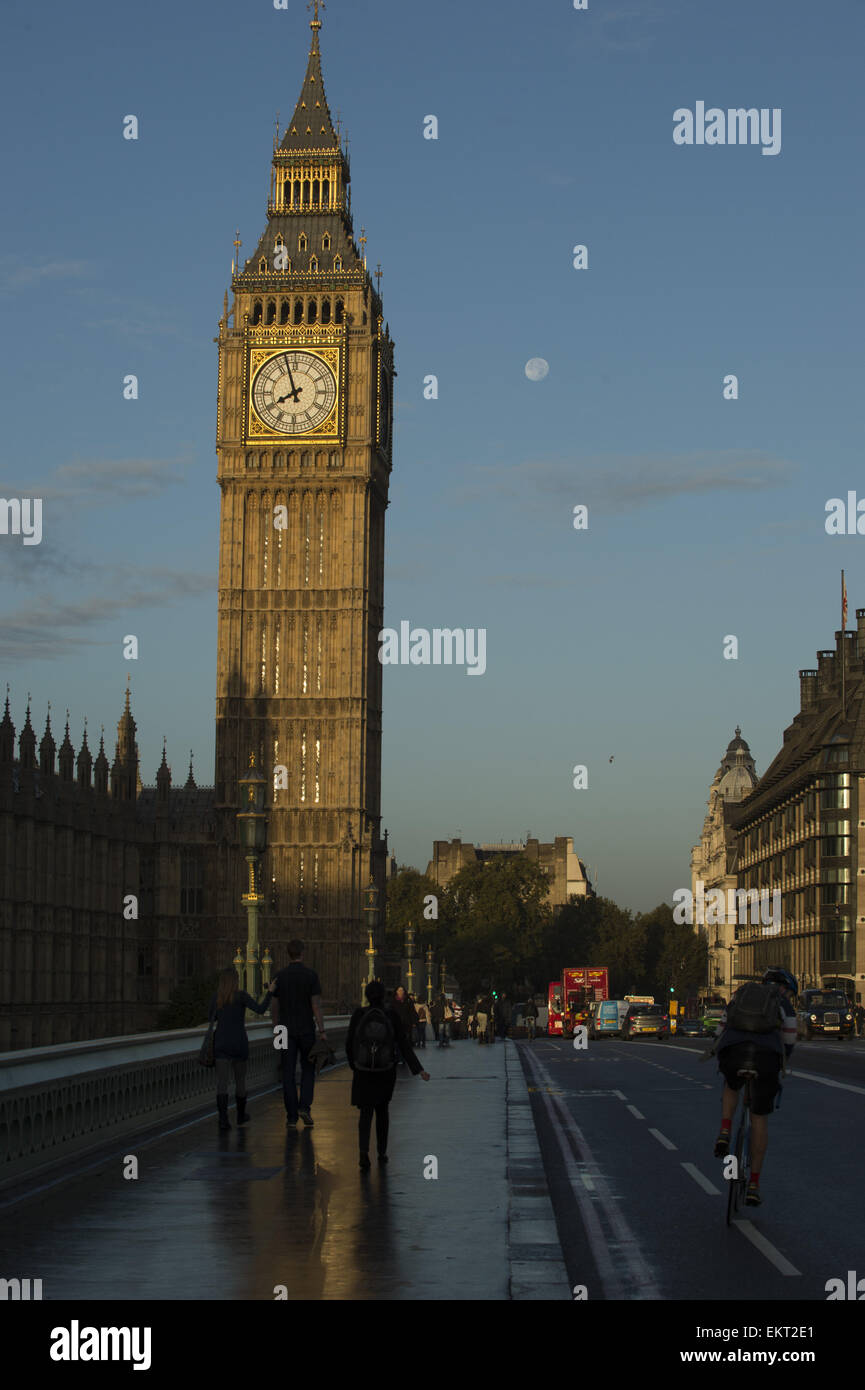 The sun rises over Big Ben in London with the moon still visible ...