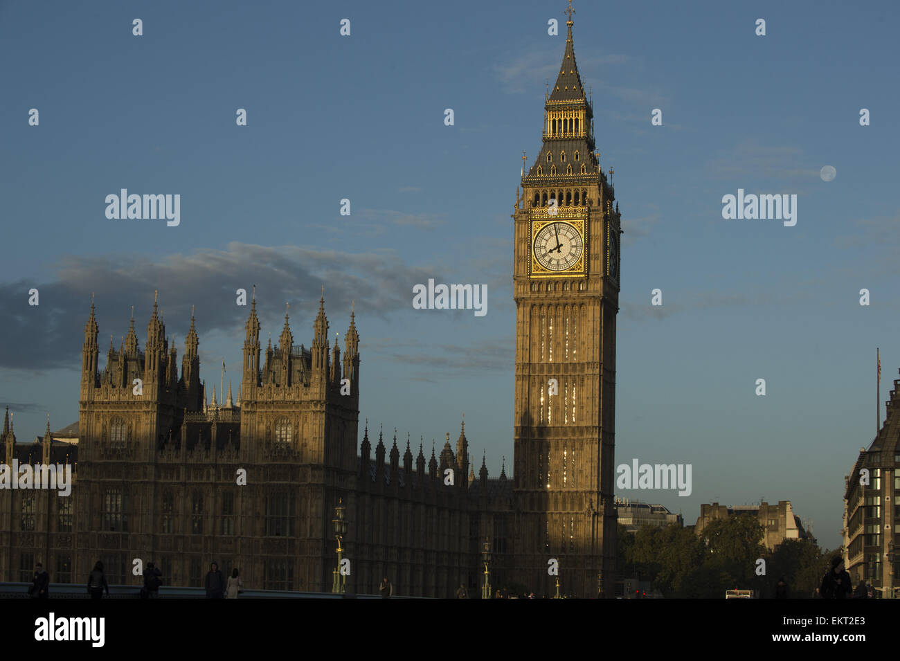 The sun rises over Big Ben in London with the moon still visible ...