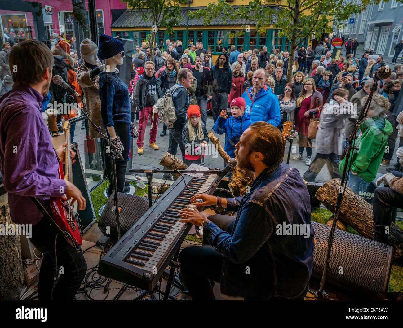 Band playing in a store- crowd look on, annual end of summer festival ...