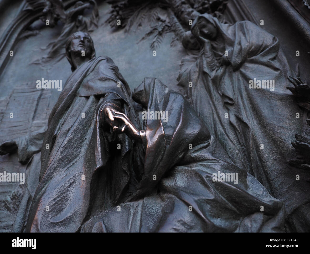 Bas- relief on the bronze door of Duomo, Piazza del Duomo square, Milan ...