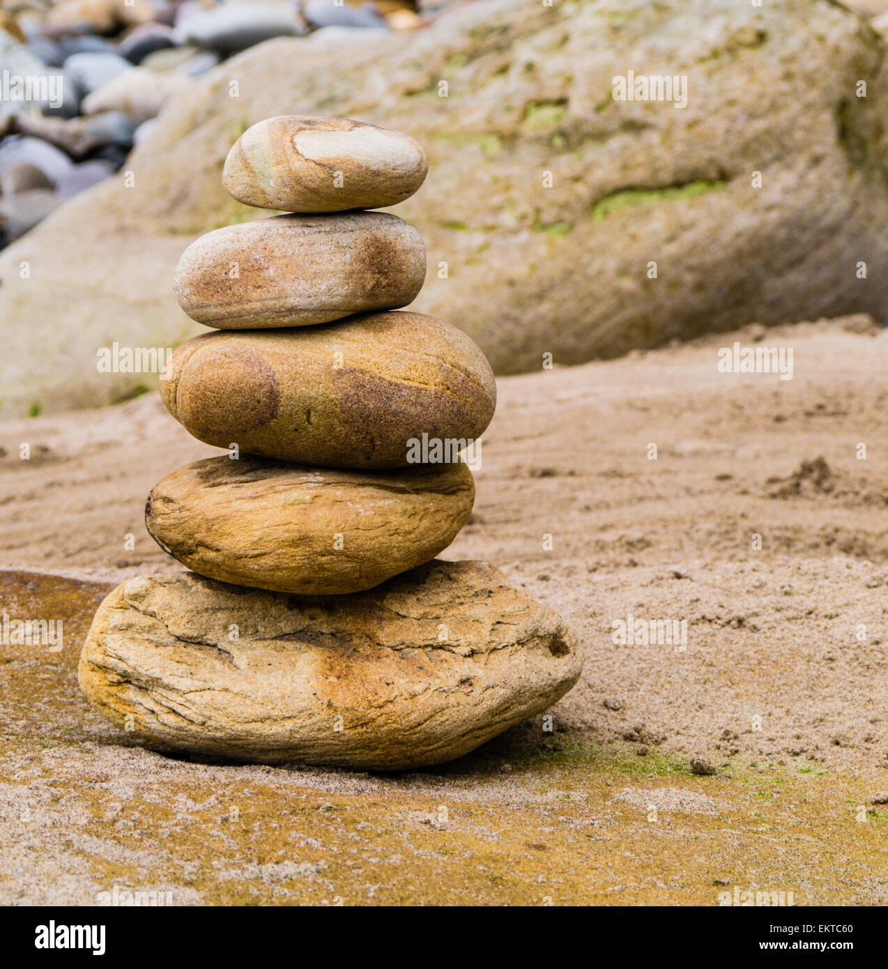 Standing stone stack on sandy beach Stock Photo - Alamy