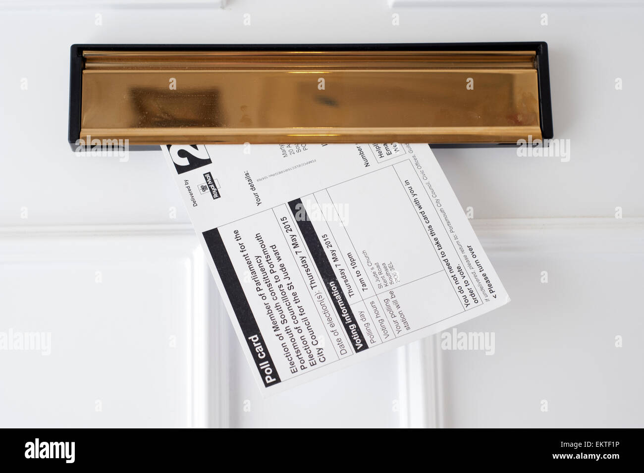 voting card for general election poking through a letter box in front ...