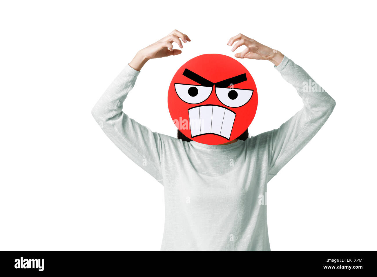 Young woman with a angry emoticon face in front of her face Stock Photo ...