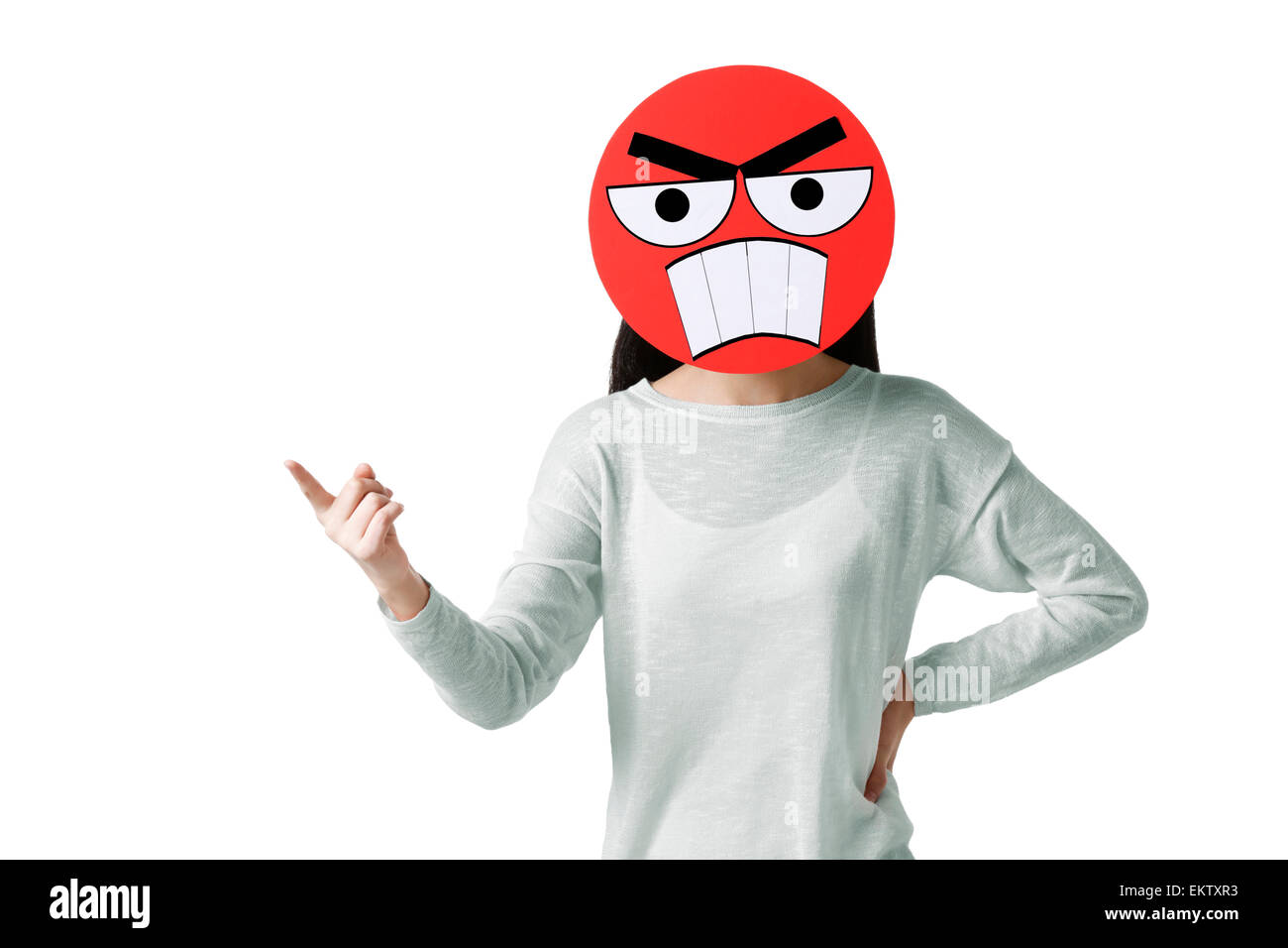Young woman with a angry emoticon face in front of her face Stock Photo ...