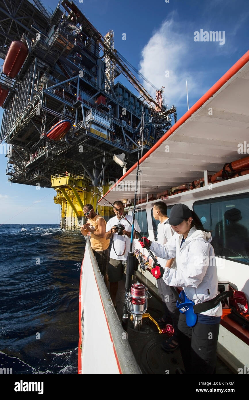 People fishing off boat beside perdido oil rig;Corpus christi texas usa ...