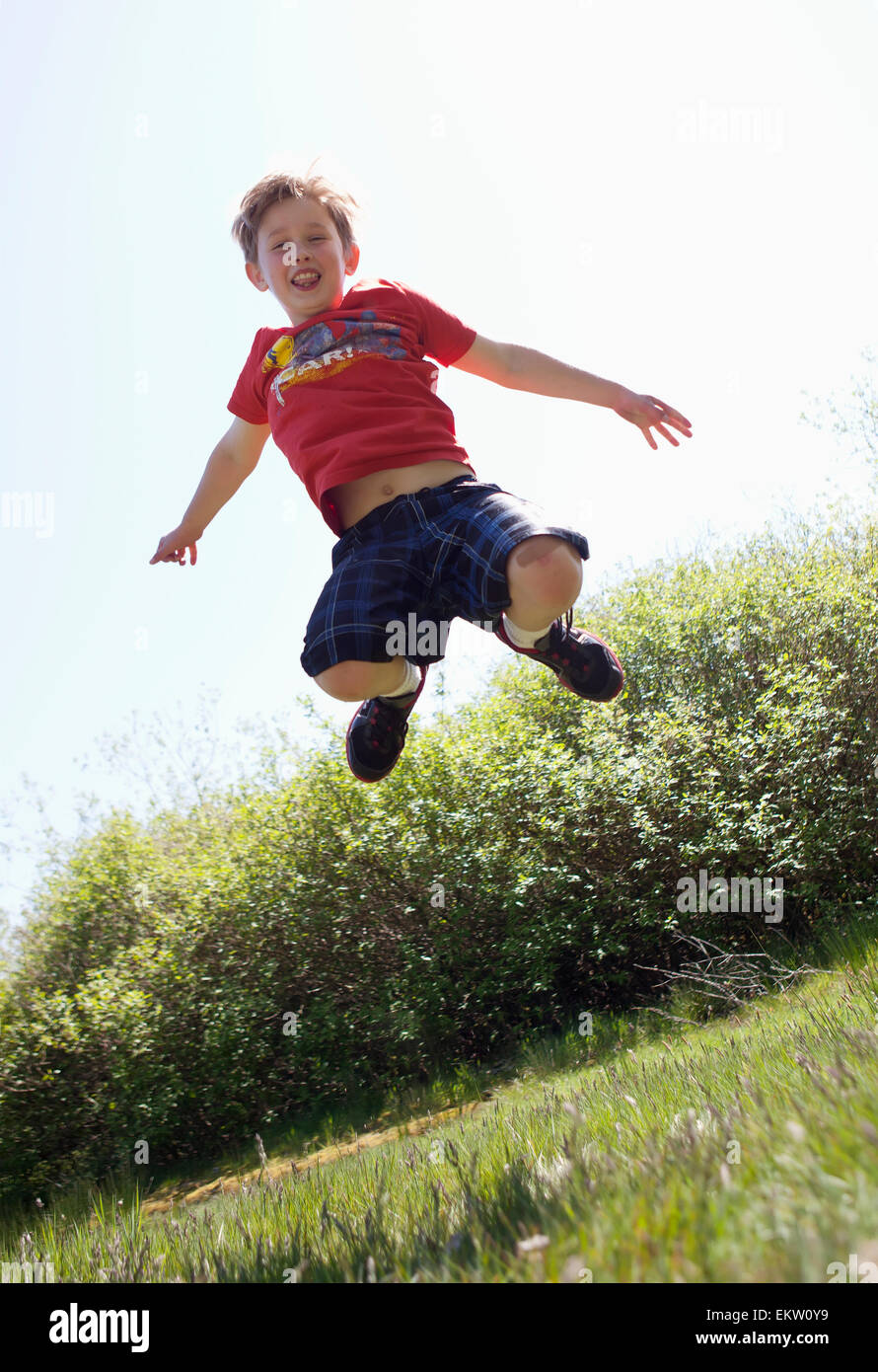 10-Year-Old Boy Jumping In Mid-Air Outdoors;Langley British Columbia ...