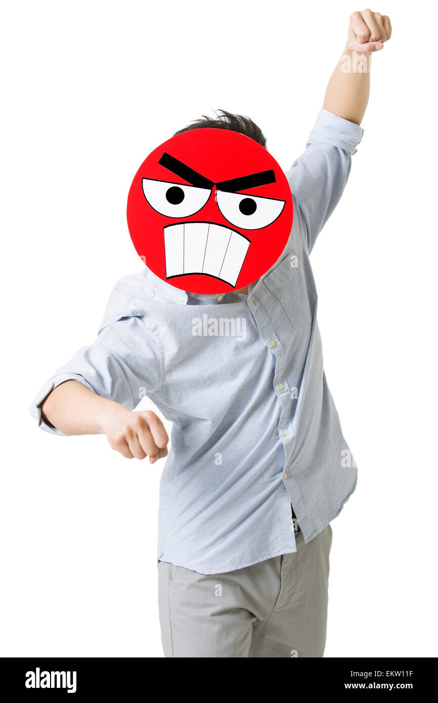 Young man with a angry emoticon face in front of his face Stock Photo ...