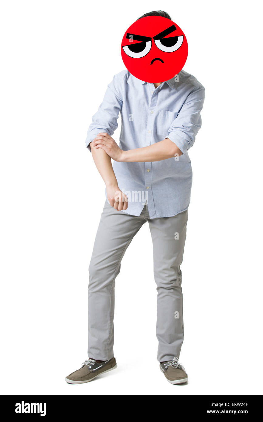 Young man with a angry emoticon face in front of his face Stock Photo ...
