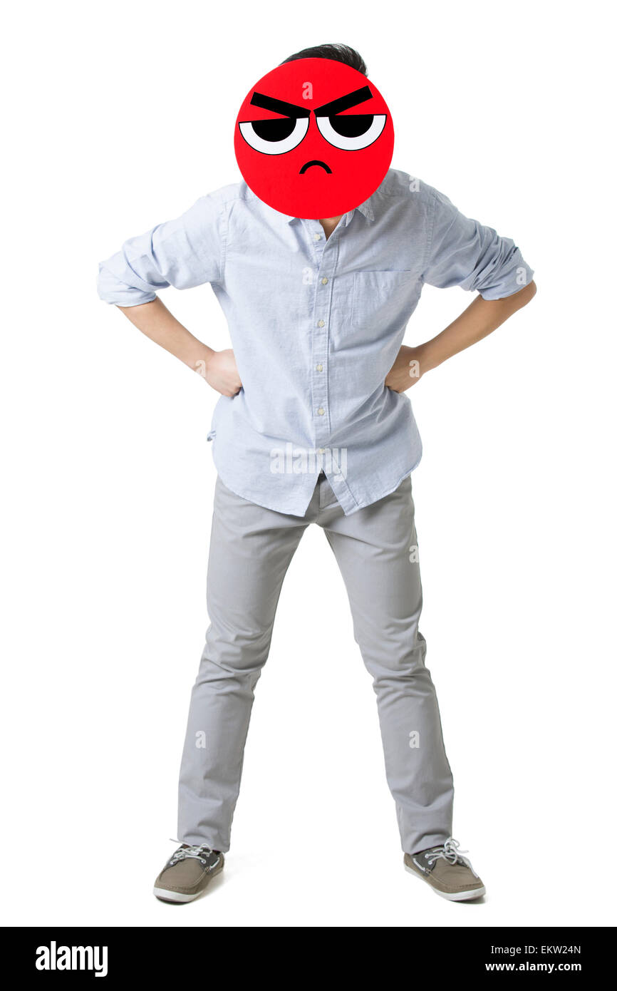 Young man with a angry emoticon face in front of his face Stock Photo ...