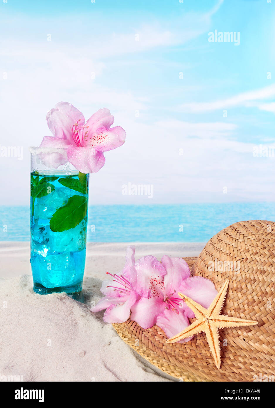 Pink flowers on a blue cocktail on the beach Stock Photo - Alamy