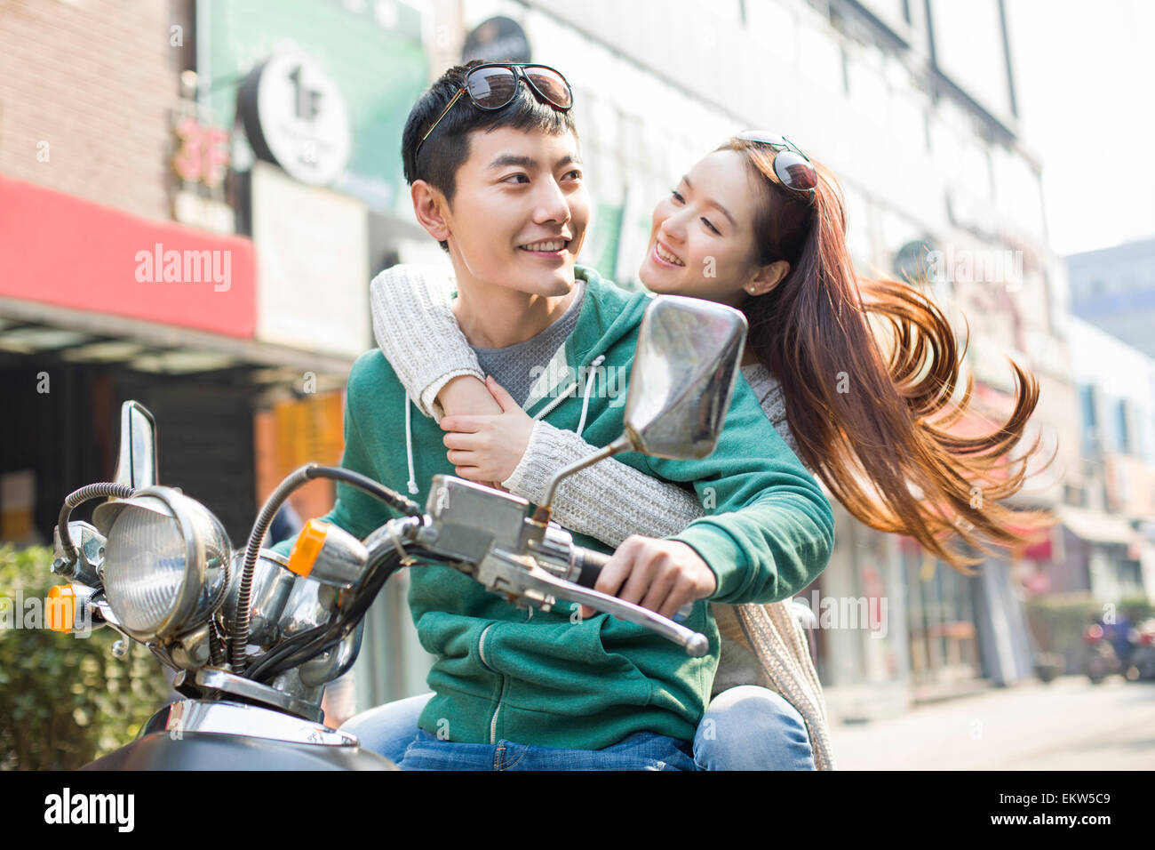 Young couple riding motorcycle together Stock Photo - Alamy