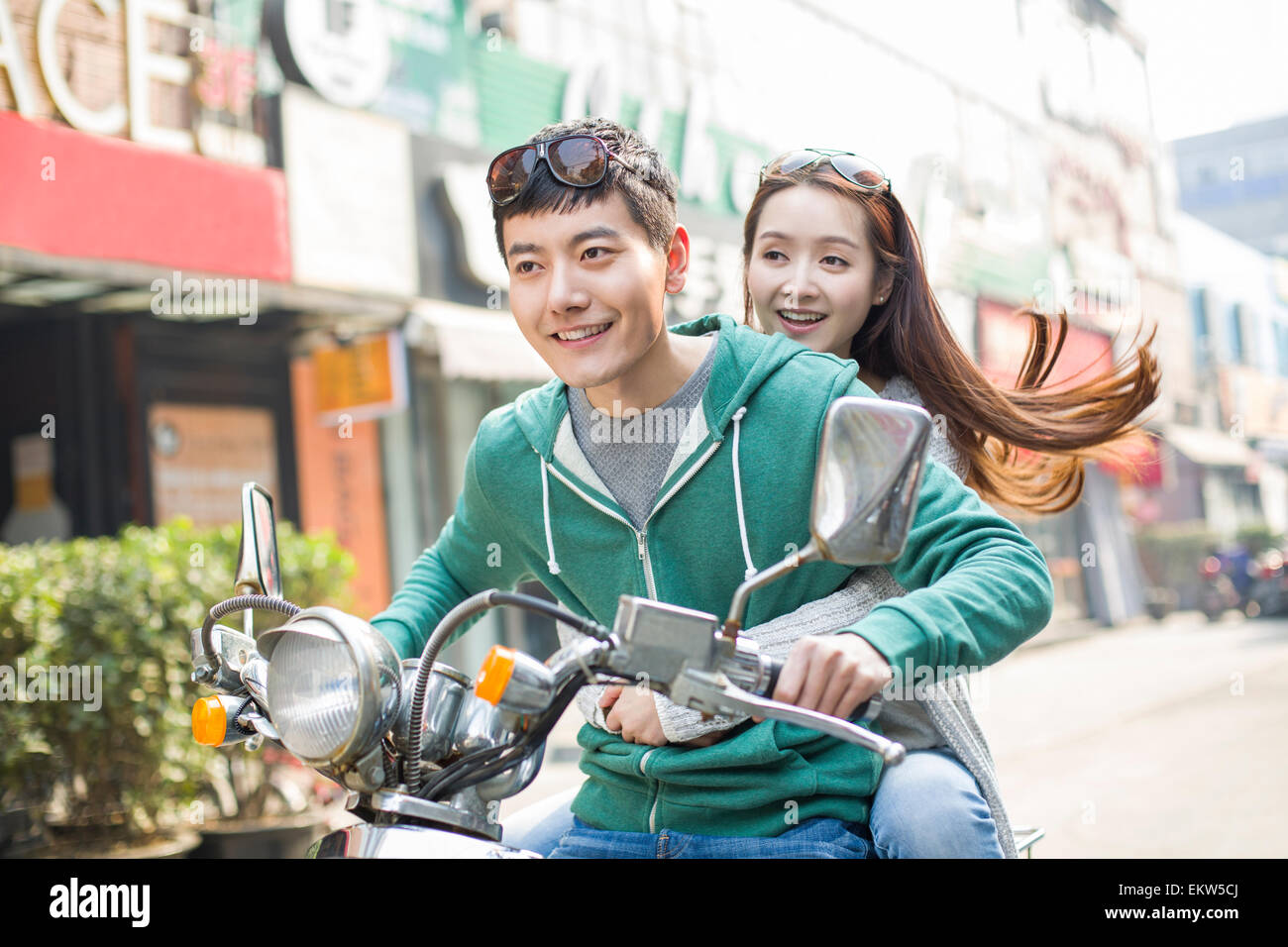 Young couple riding motorcycle together Stock Photo - Alamy