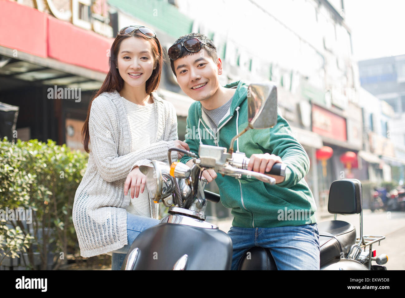 Young couple riding motorcycle together Stock Photo - Alamy