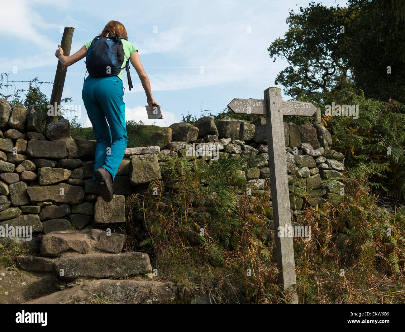 Person climbing over wall hi-res stock photography and images - Alamy