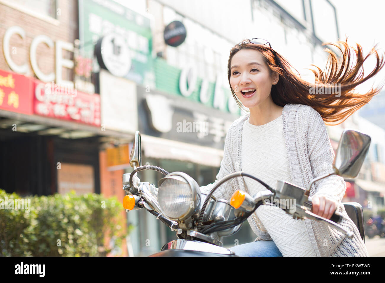 Young woman riding motorcycle Stock Photo - Alamy
