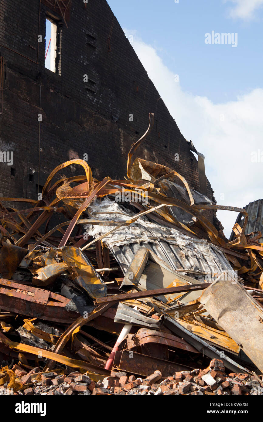 Fire damaged building with outer wall remaining standing and collapsed ...
