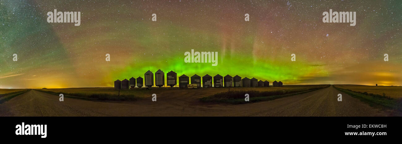 A 180 degree panorama of a modest aurora display behind grain bins on a ...