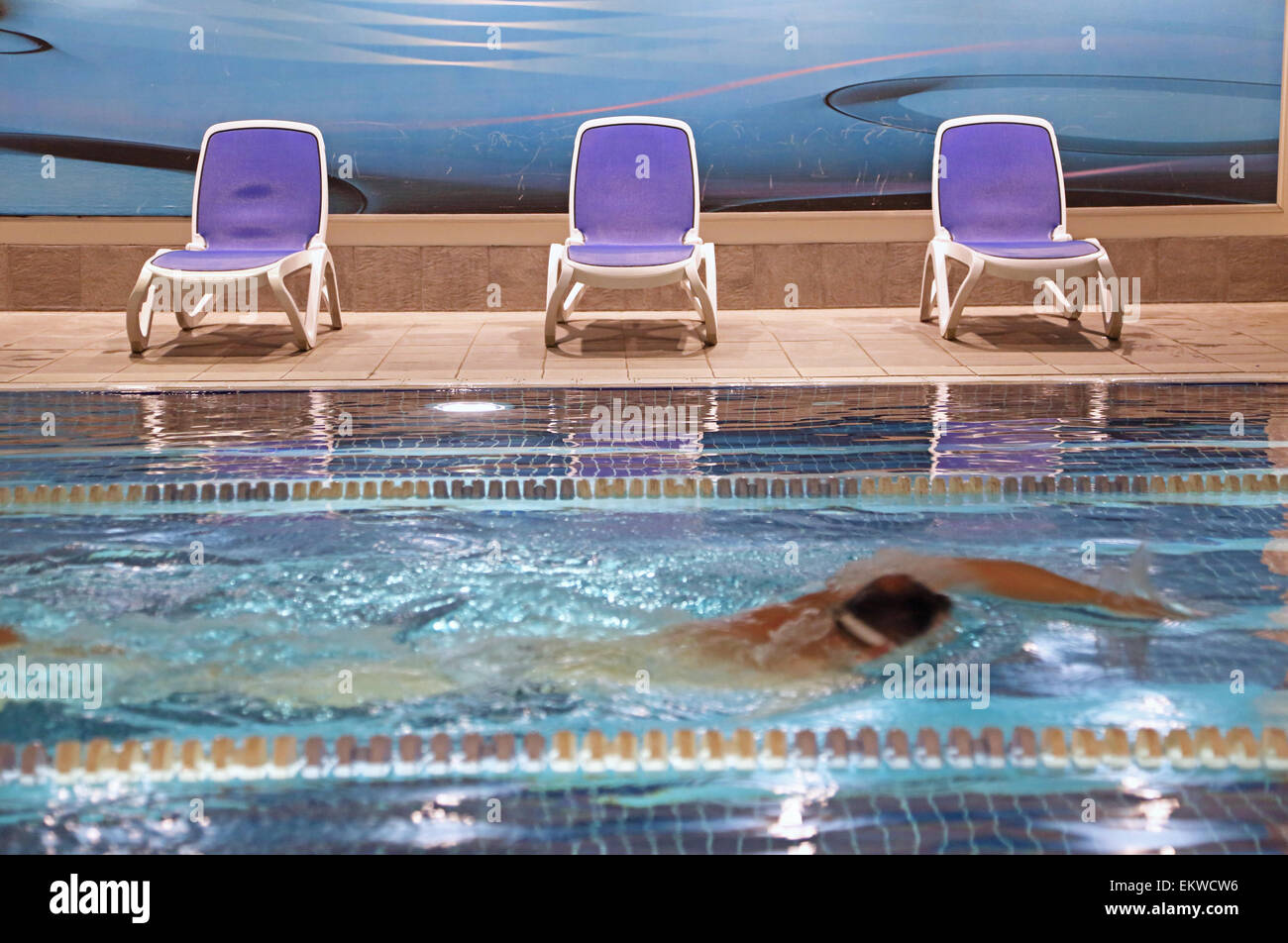 Lane swimming in a private London basement pool. Shows an ...