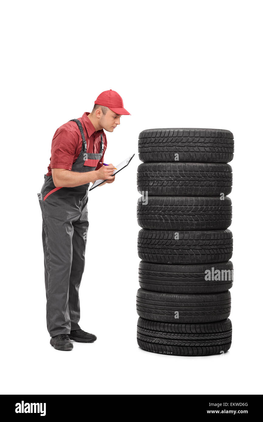 Full length portrait of a young mechanic checking the quality of a set ...