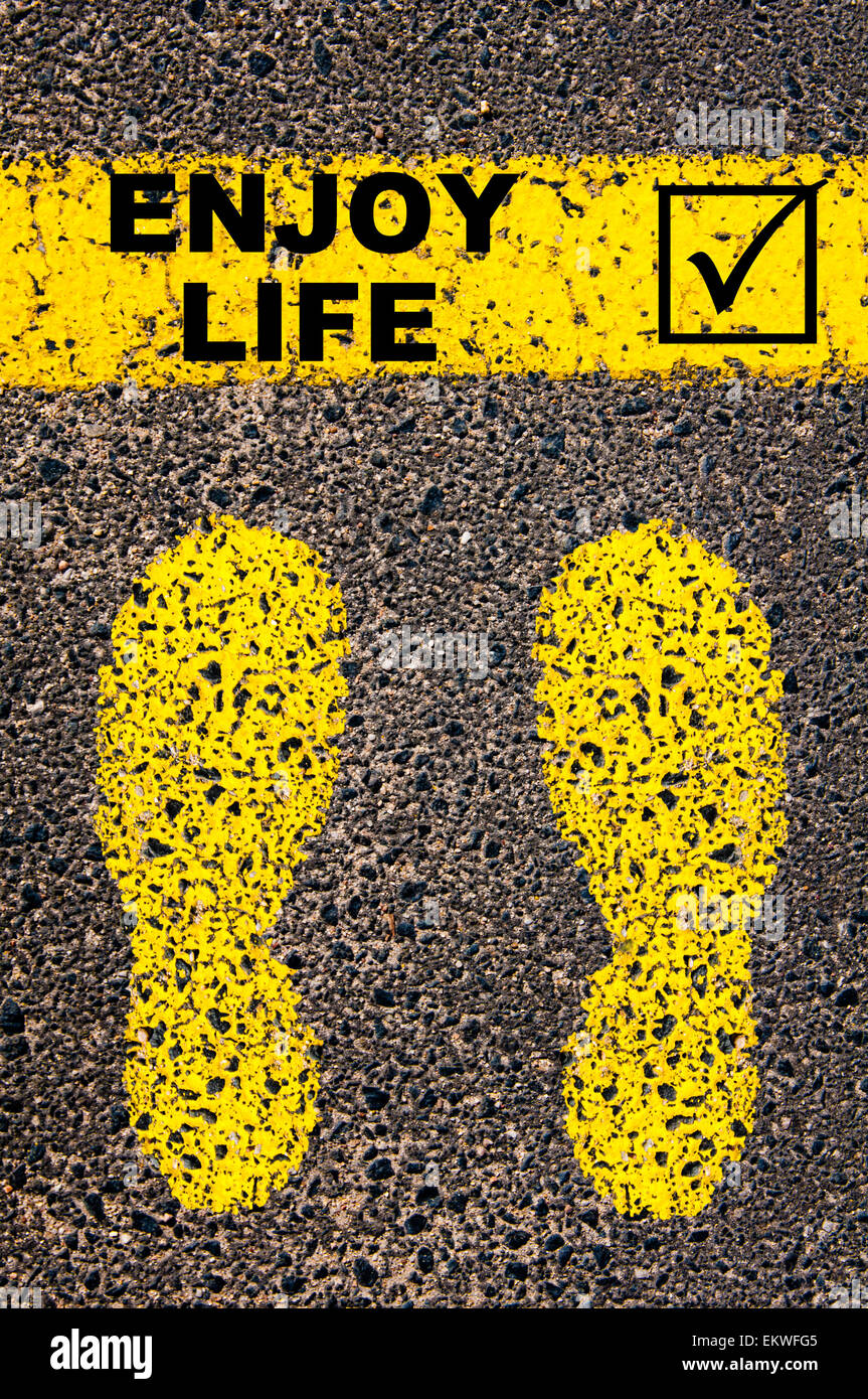 Conceptual image with yellow paint footsteps on the road in front of ...