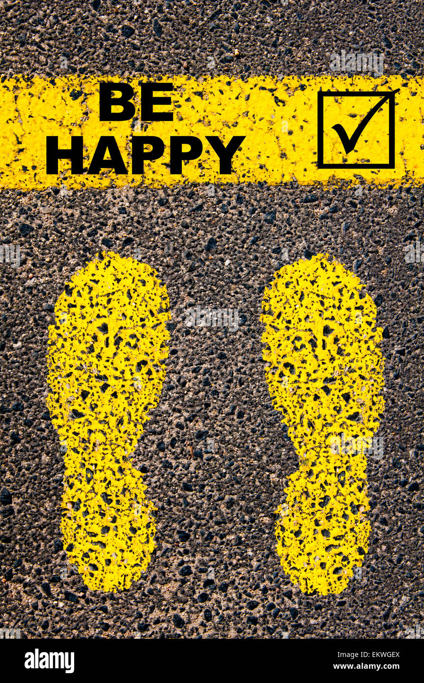 Conceptual image with yellow paint footsteps on the road in front of ...