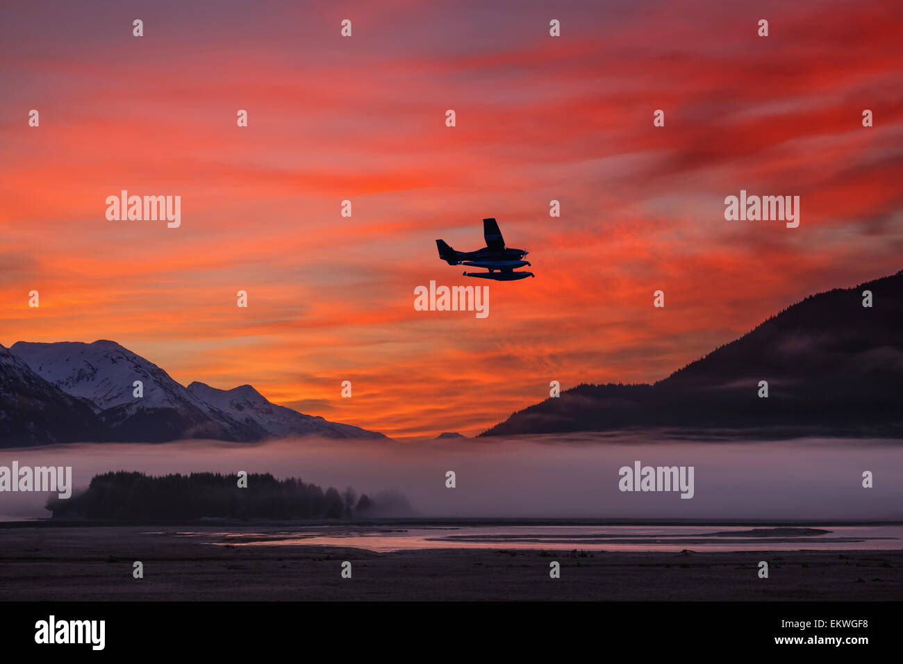 Floatplane takes off from Juneau as the fog begins to clear at sunrise ...