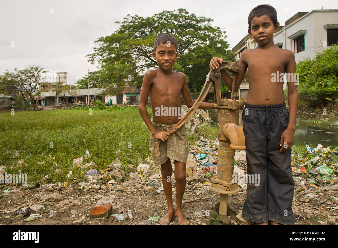 Two Boys At A Central Well In The Slums; Sylhet, Bangladesh Stock Photo ...