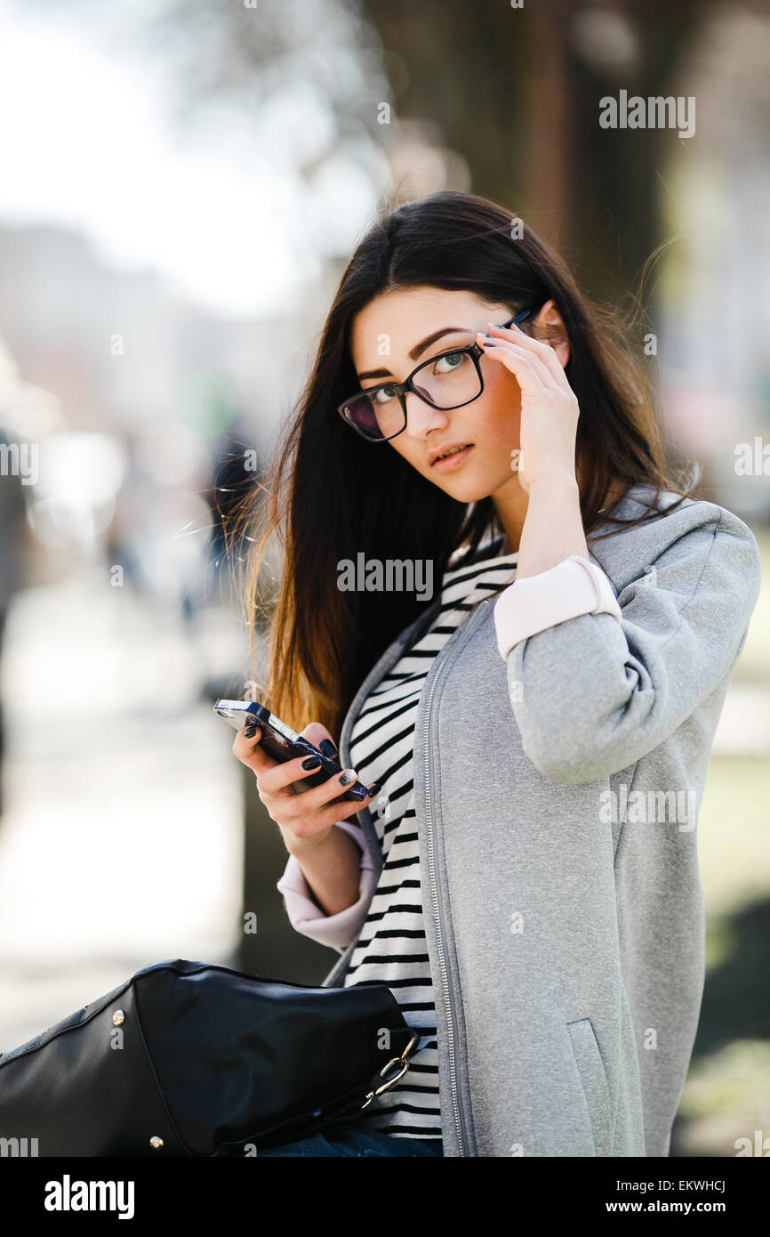 Beautiful fashion model in glasses sits Stock Photo - Alamy