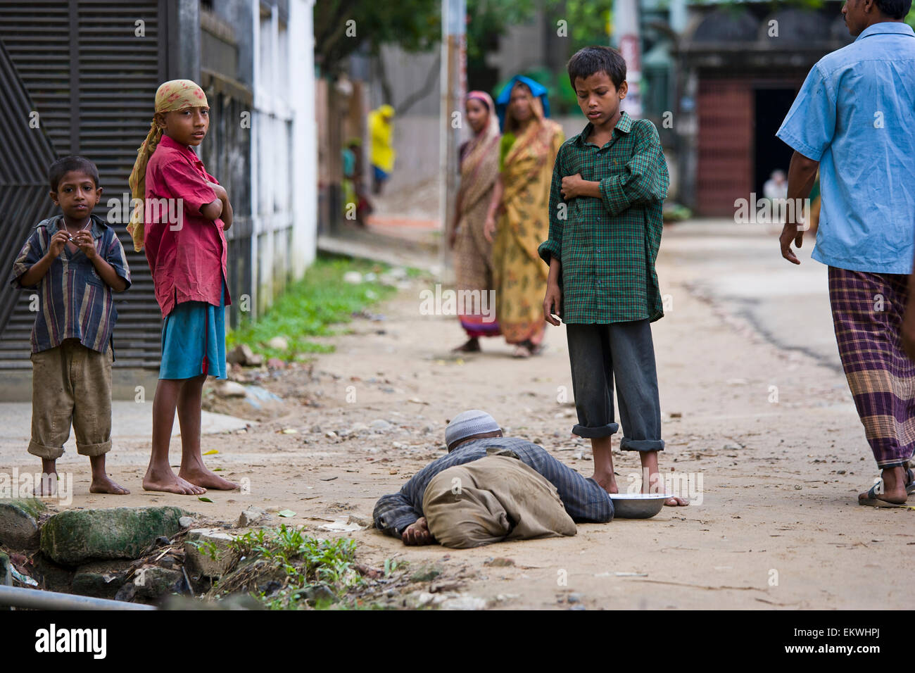Children Standing Around A Man Laying On The Ground In The Slums ...