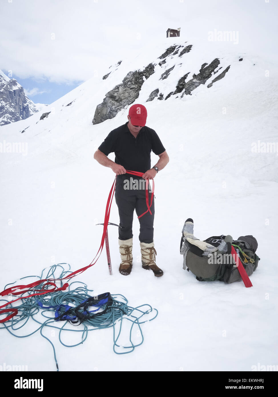 Man rigging up a harness near the Don Sheldon Mountain House, Interior ...