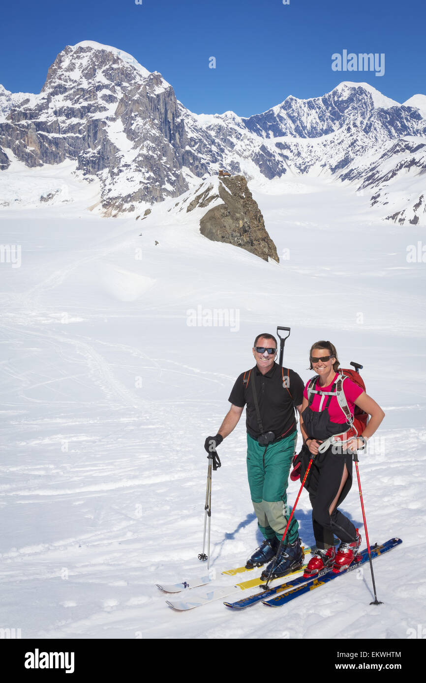 A couple telemark skiing on the Ruth Glacier near the Don Sheldon ...