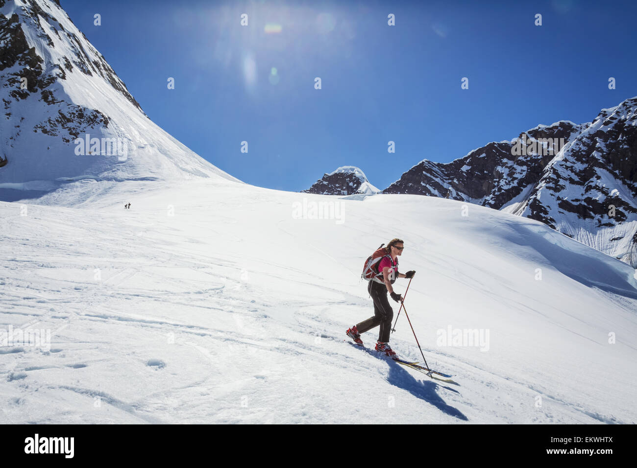 A woman skiing on the Ruth Glacier below the Don Sheldon Mountain House ...