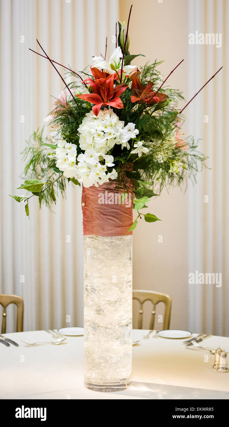 A vase of cut flowers on a table for a wedding Stock Photo - Alamy