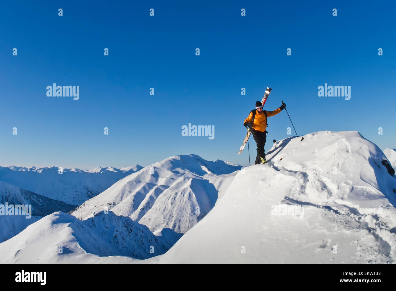 Man climbing a snow ridge for back country skiing, Turnagain Pass ...