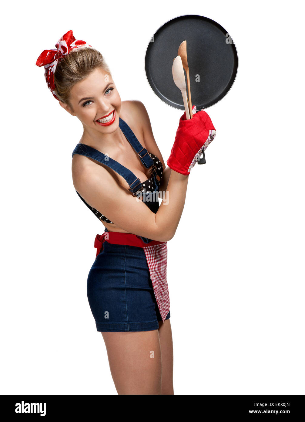 Appealing maid wearing apron with kitchen utensils Stock Photo - Alamy