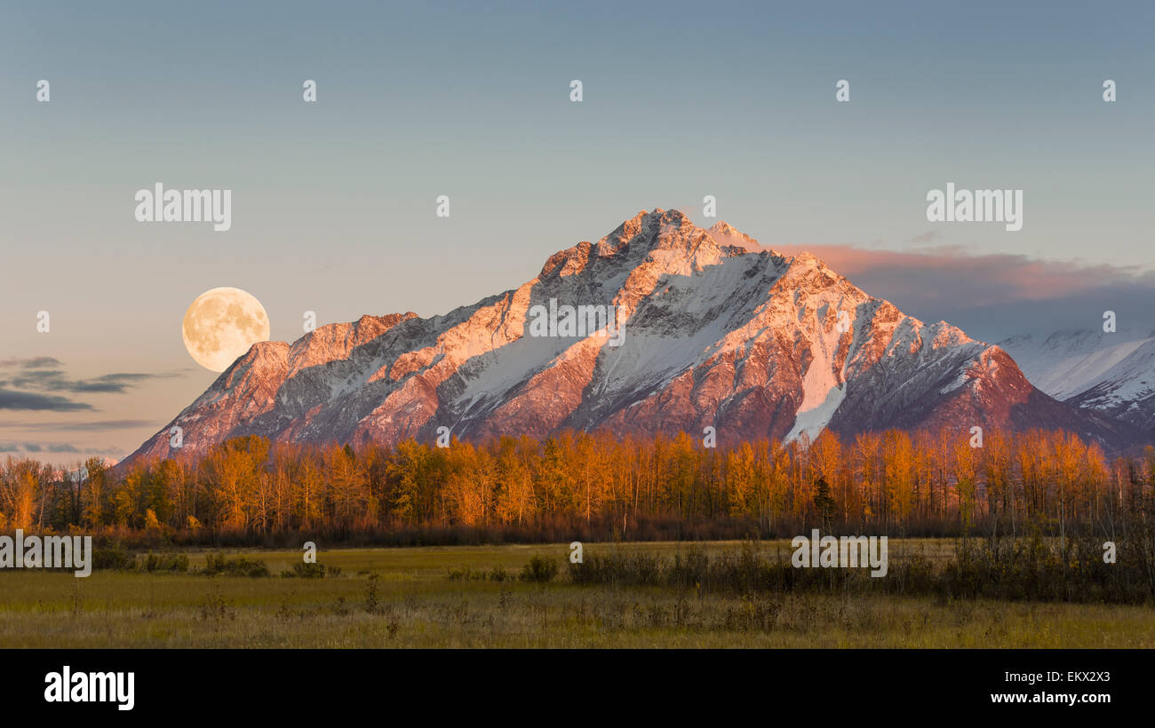 COMPOSITE: Scenic sunset view of Pioneer Peak with the full moon rising ...